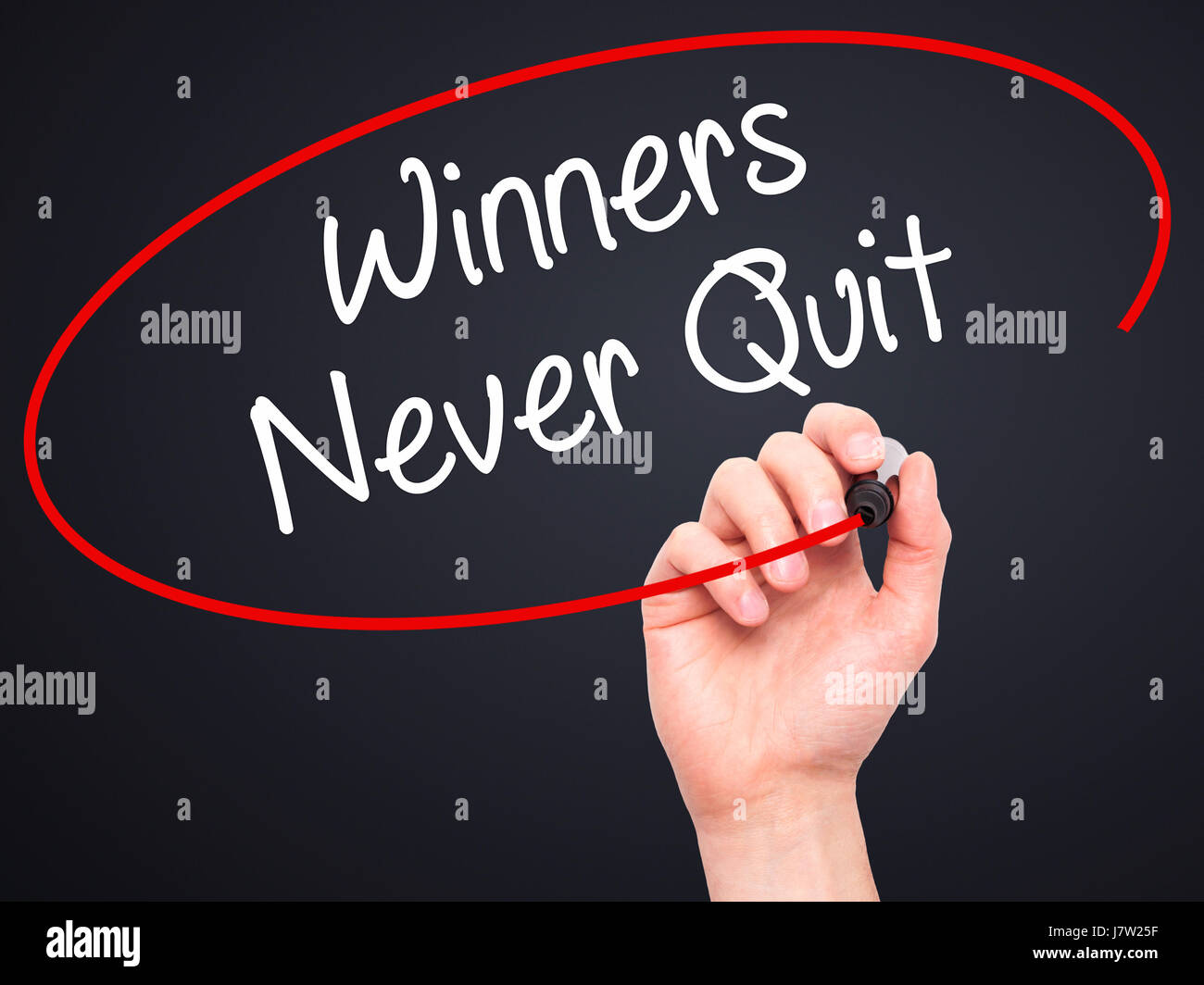 Man Hand writing Winners Never Quit with black marker on visual screen ...