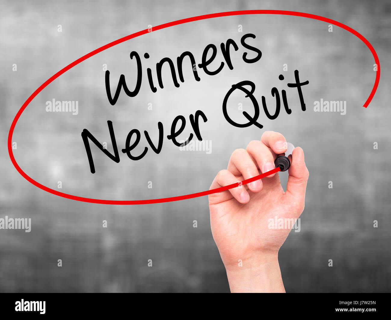 Man Hand writing Winners Never Quit with black marker on visual screen ...