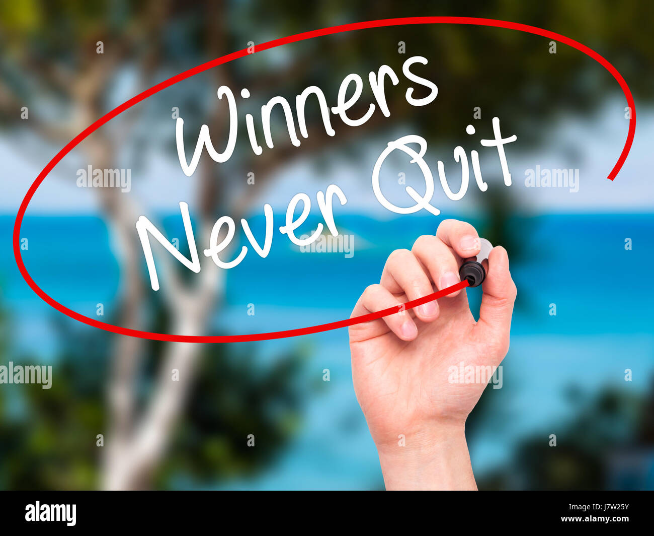 Man Hand writing Winners Never Quit with black marker on visual screen ...