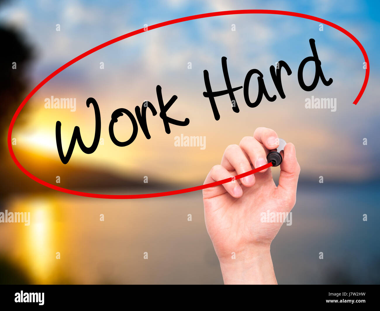 Man Hand writing Work Hard with black marker on visual screen. Isolated ...