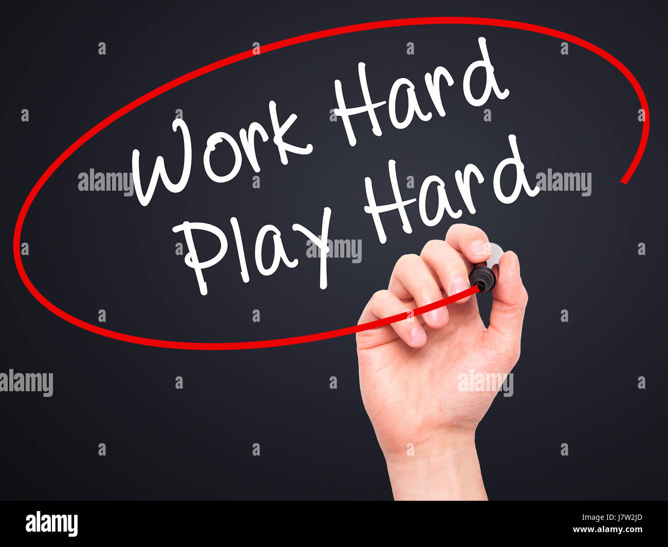 Man Hand writing Work Hard Play Hard with black marker on visual screen ...