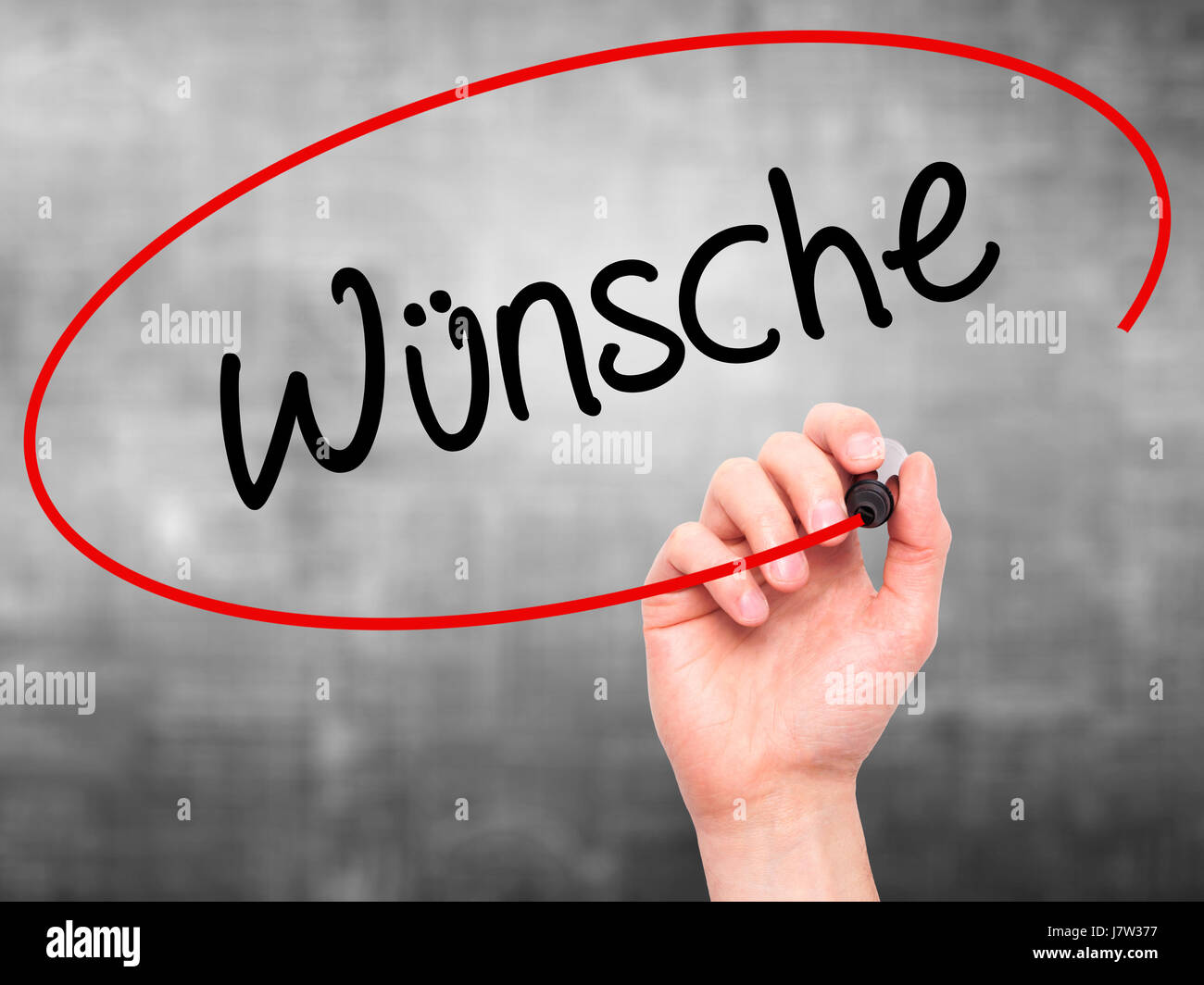 Man Hand writing Wunsche (Wishes in German) with black marker on visual ...
