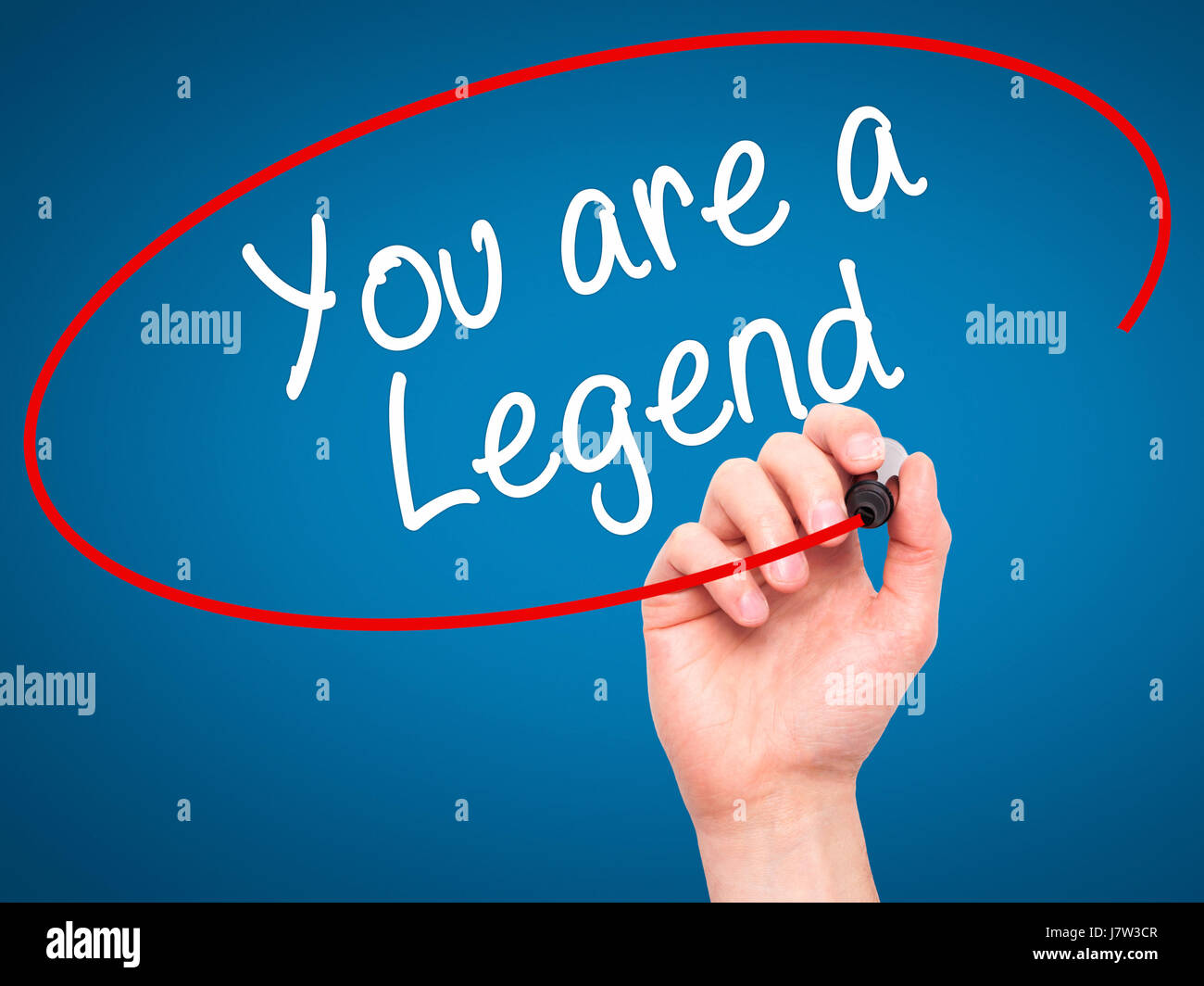 Man Hand writing You are a Legend with black marker on visual screen ...
