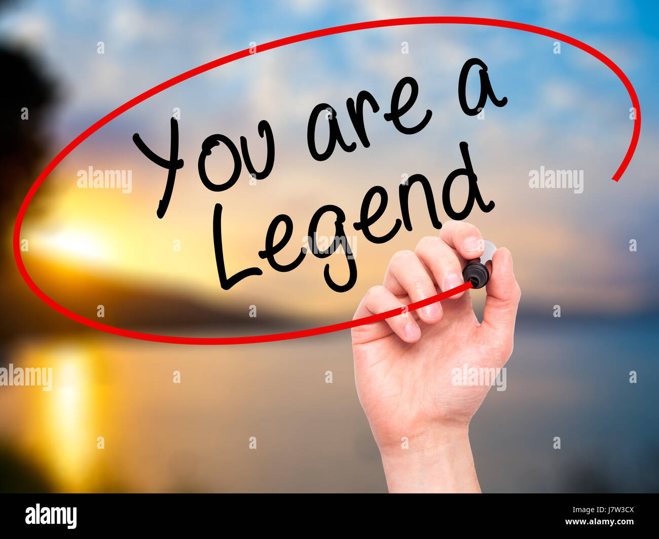 Man Hand writing You are a Legend with black marker on visual screen ...