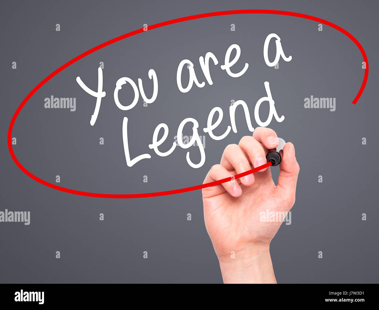 Man Hand writing You are a Legend with black marker on visual screen ...