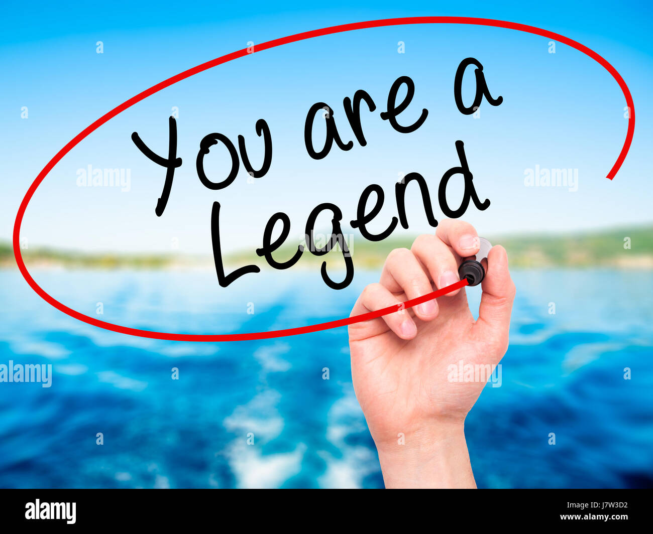 Man Hand writing You are a Legend with black marker on visual screen ...