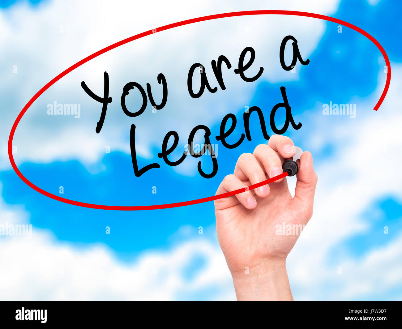 Man Hand writing You are a Legend with black marker on visual screen ...
