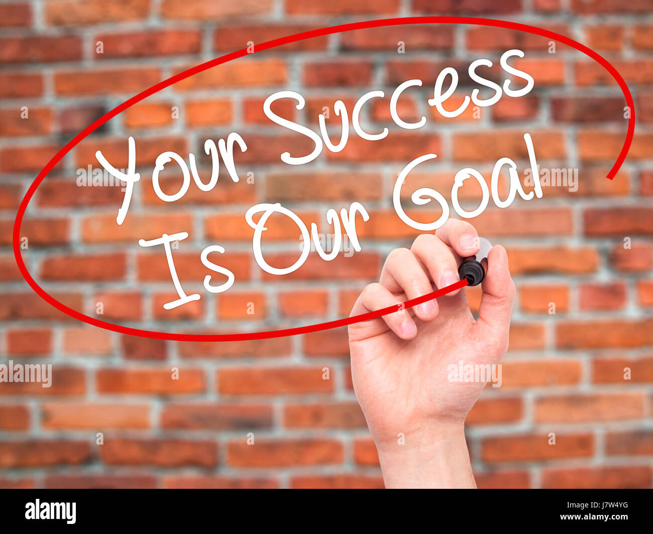 Man Hand writing Your Success Is Our Goal with black marker on visual ...