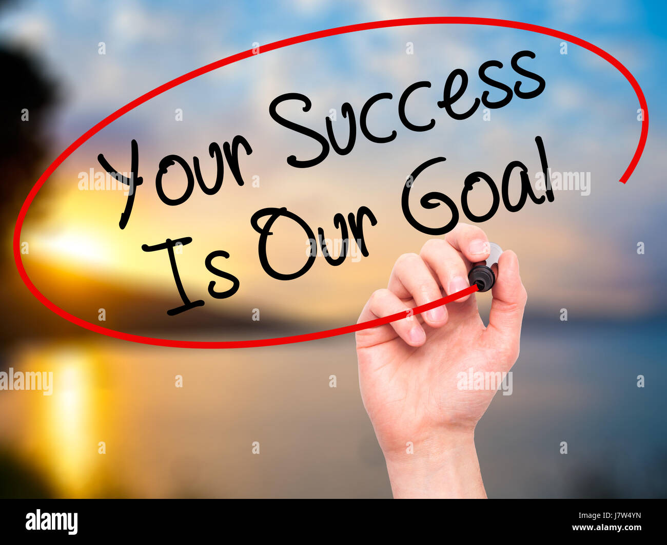 Man Hand writing Your Success Is Our Goal with black marker on visual ...