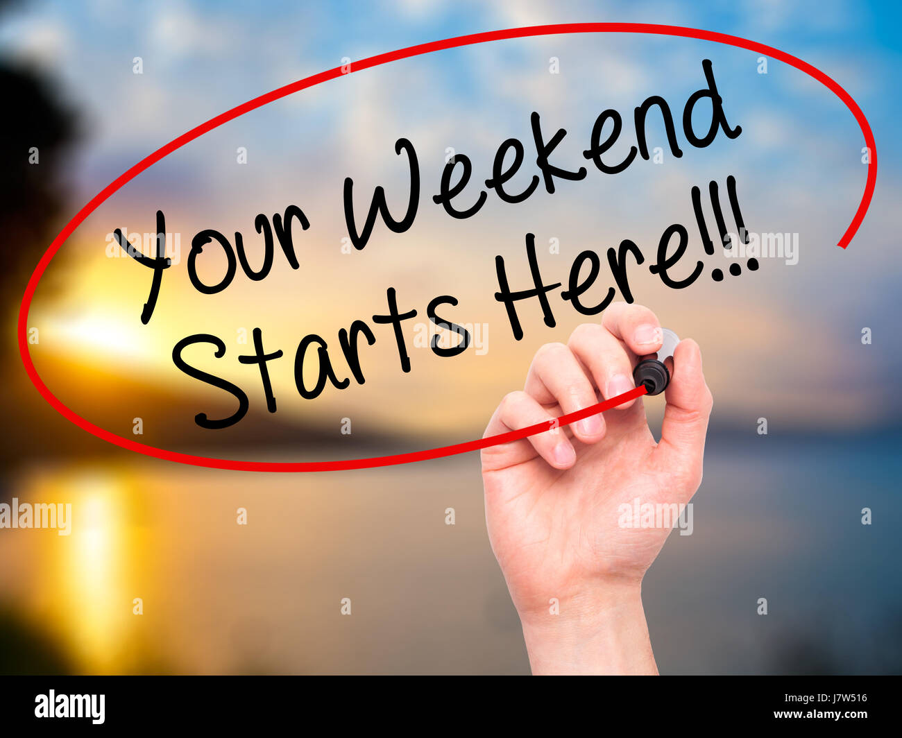 Man Hand writing Your Weekend Starts Here!!! with black marker on ...