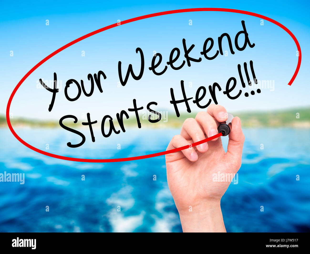 Man Hand writing Your Weekend Starts Here!!! with black marker on ...