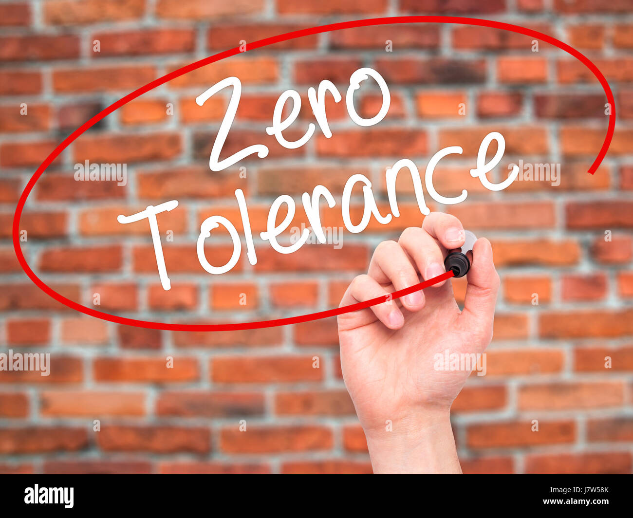 Man Hand writing Zero Tolerance with black marker on visual screen ...