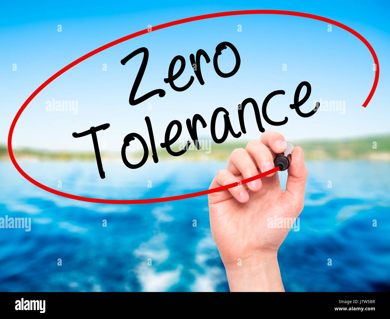 Man Hand writing Zero Tolerance with black marker on visual screen ...