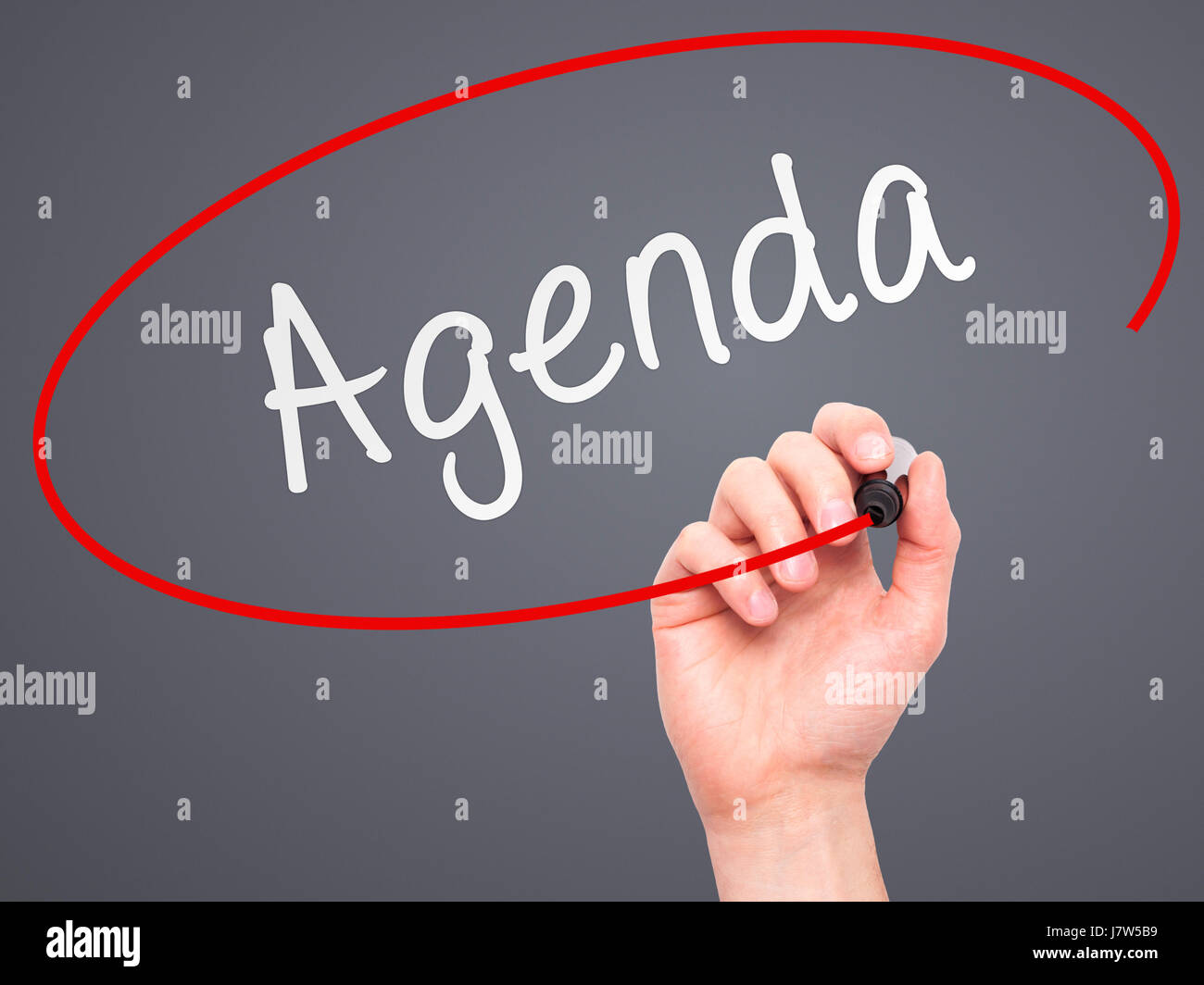 Man Hand writing Agenda with marker on transparent wipe board. Isolated ...