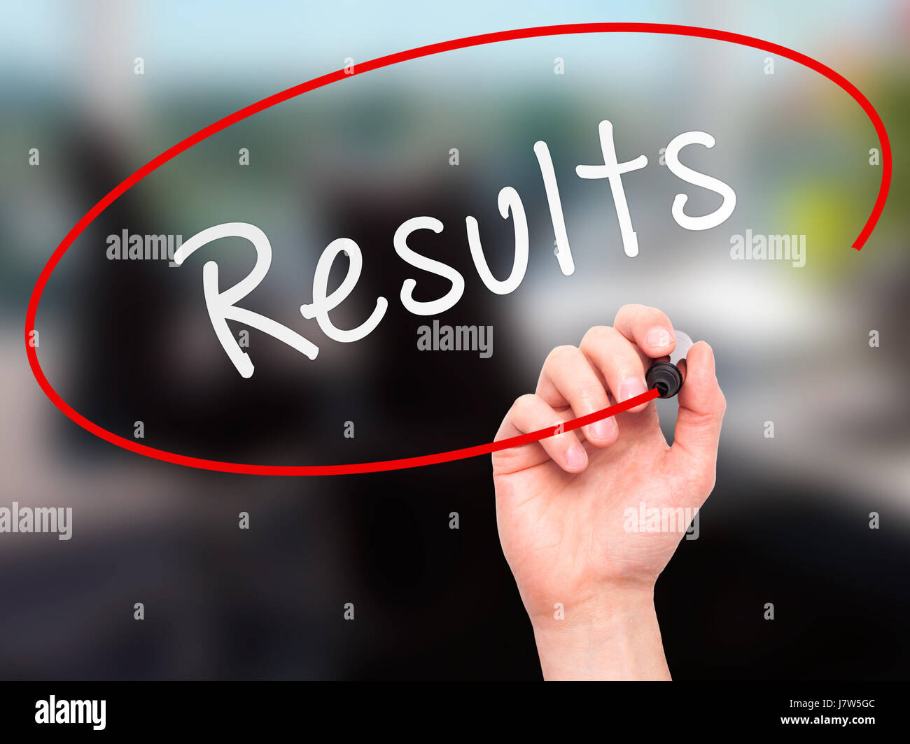 Man Hand writing Results with marker on transparent wipe board ...