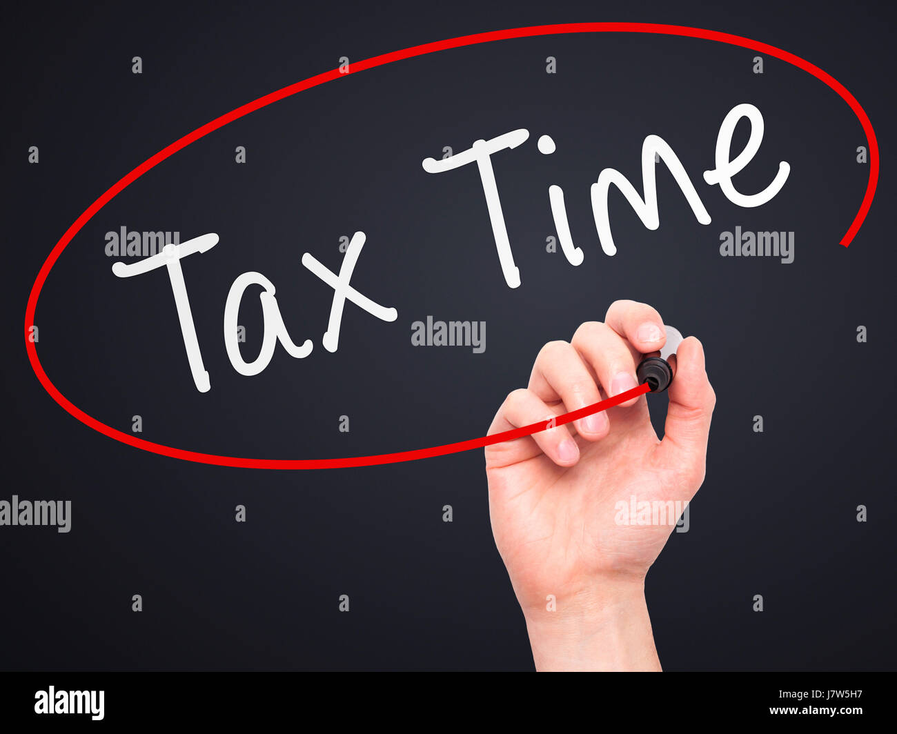Man Hand writing Tax Time with marker on transparent wipe board ...