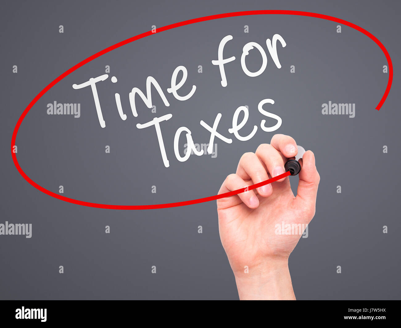Man Hand writing Time for Taxes with marker on transparent wipe board ...