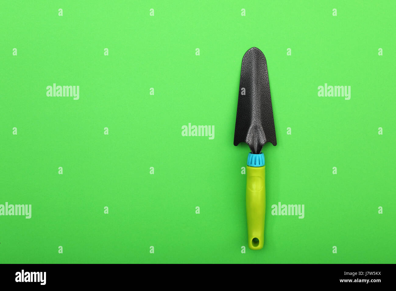 Gardening tools on a green background Stock Photo - Alamy