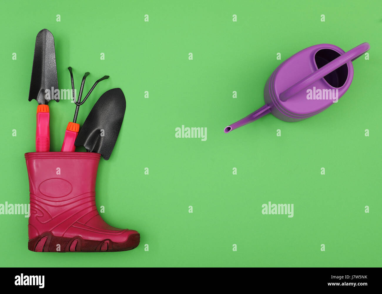 Gardening tools on a green background Stock Photo - Alamy