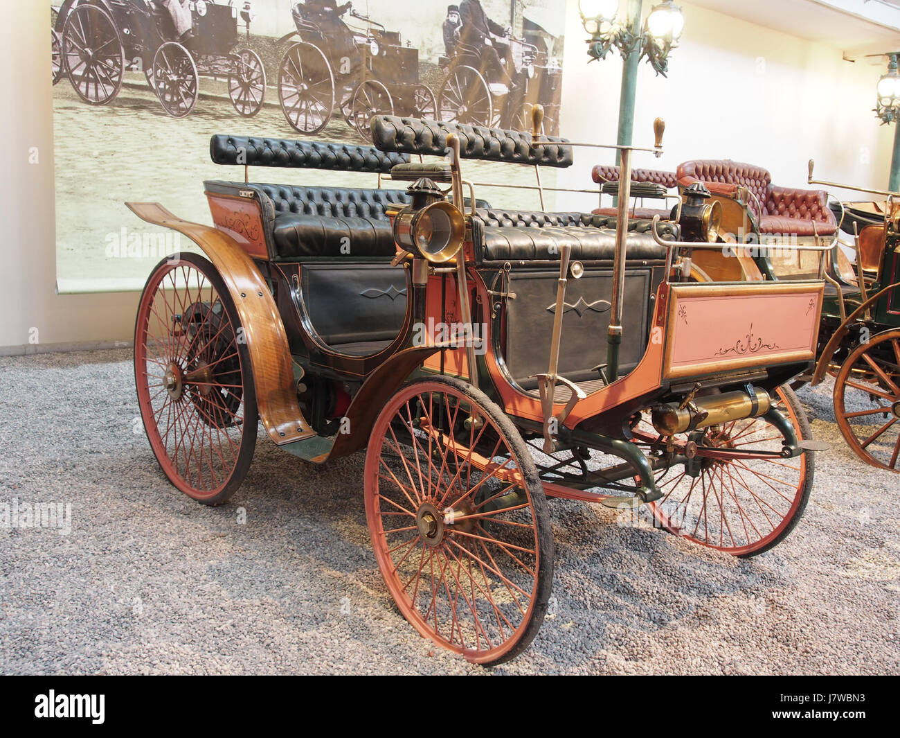 This image features a 1893 Peugeot Phaetonnet Type 8, an early model of ...