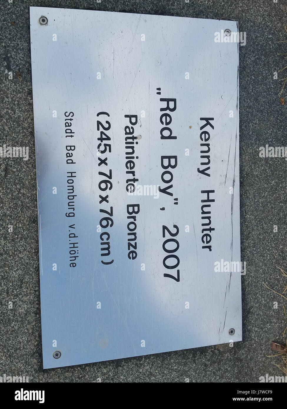 This artwork, 'Red Boy,' by Kenny Hunter, features a contemporary ...