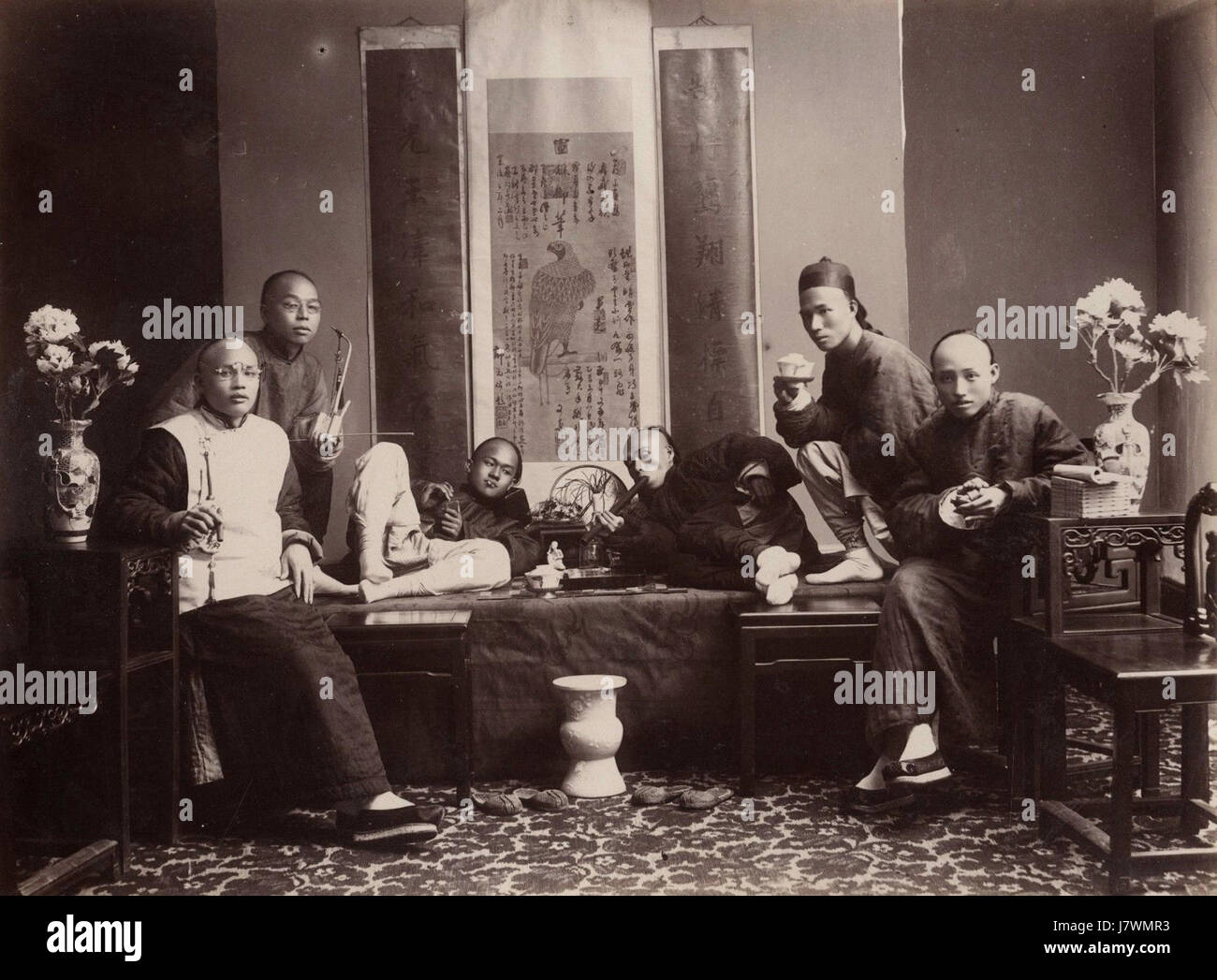 This photograph by Lai Afong, taken around 1880, depicts opium smokers ...