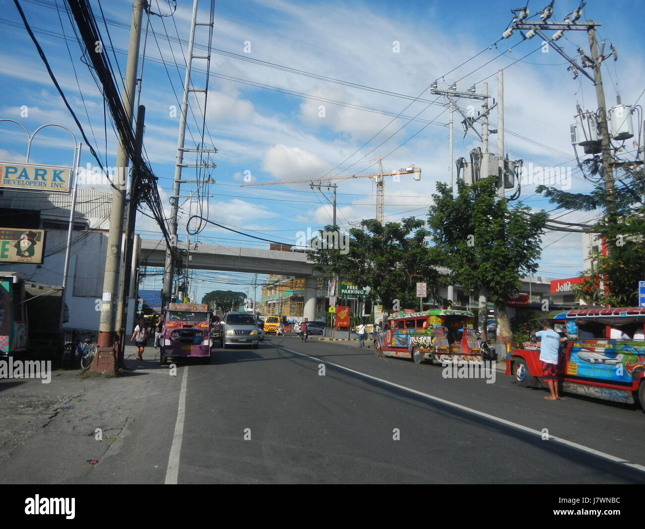 This image depicts the busy intersection of Marcos Highway, Amang ...