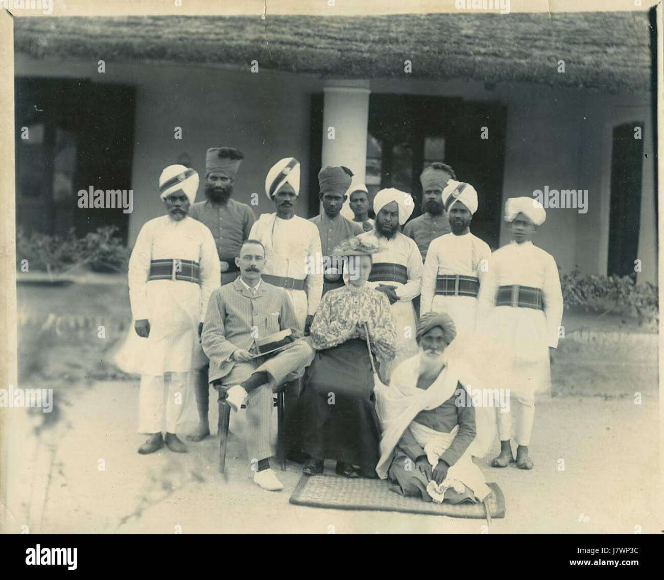 A photograph showing a British couple accompanied by Indian policemen ...