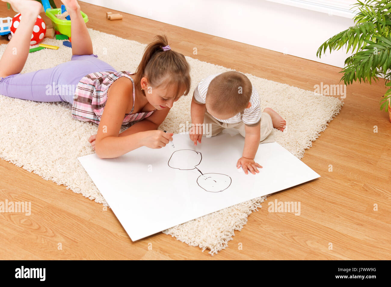 carpet boy lad male youngster sheet of paper paper girl girls drawing ...