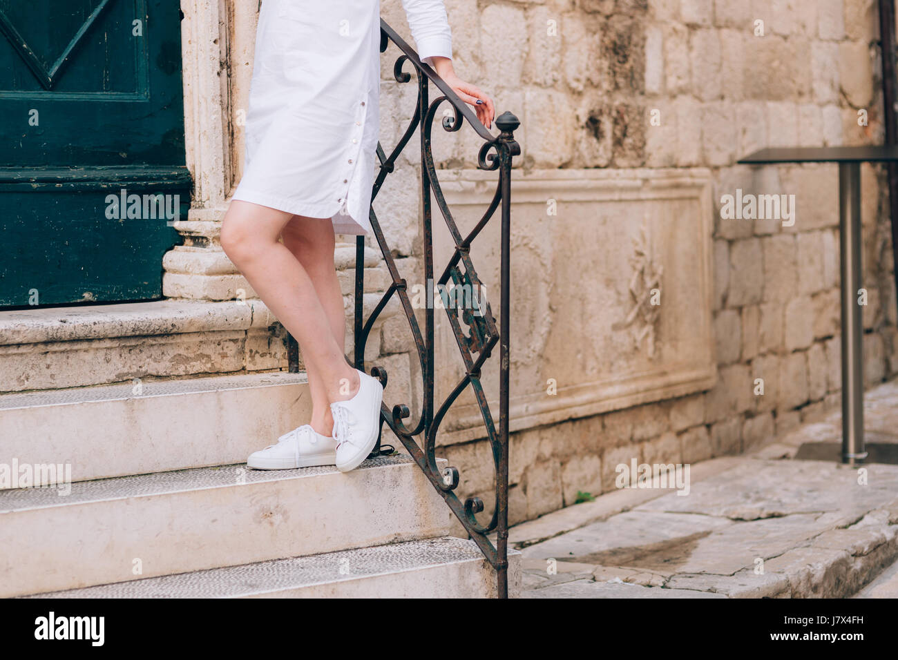 Female feet in sneakers on the steps Stock Photo - Alamy