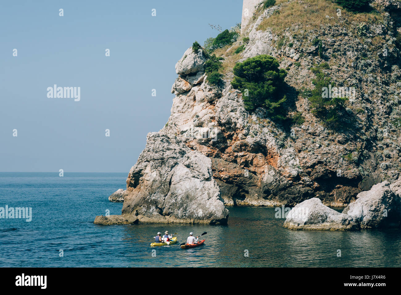 Kayaks at sea. Tourist kayaking in the sea near Dubrovnik, Croatia ...
