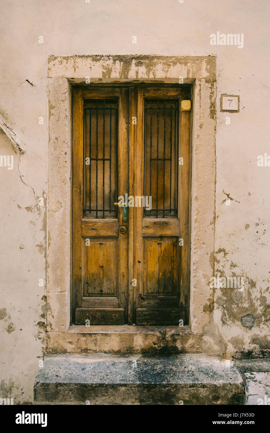 Old yellow, brown, red doors. Wood texture. Old shabby irradiated paint ...