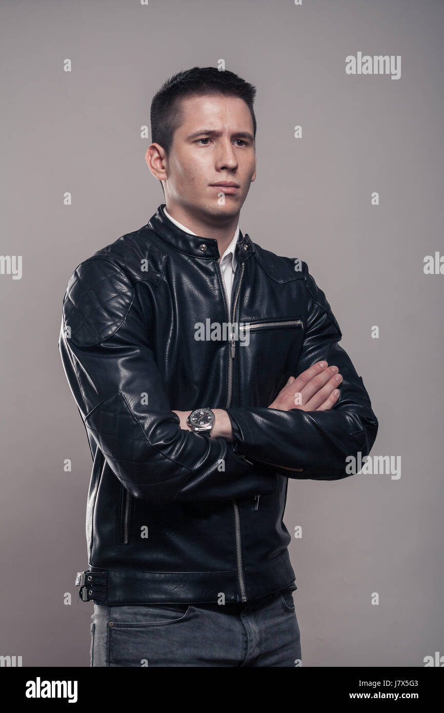one young adult man only, looking sideways, looking tense, leather ...