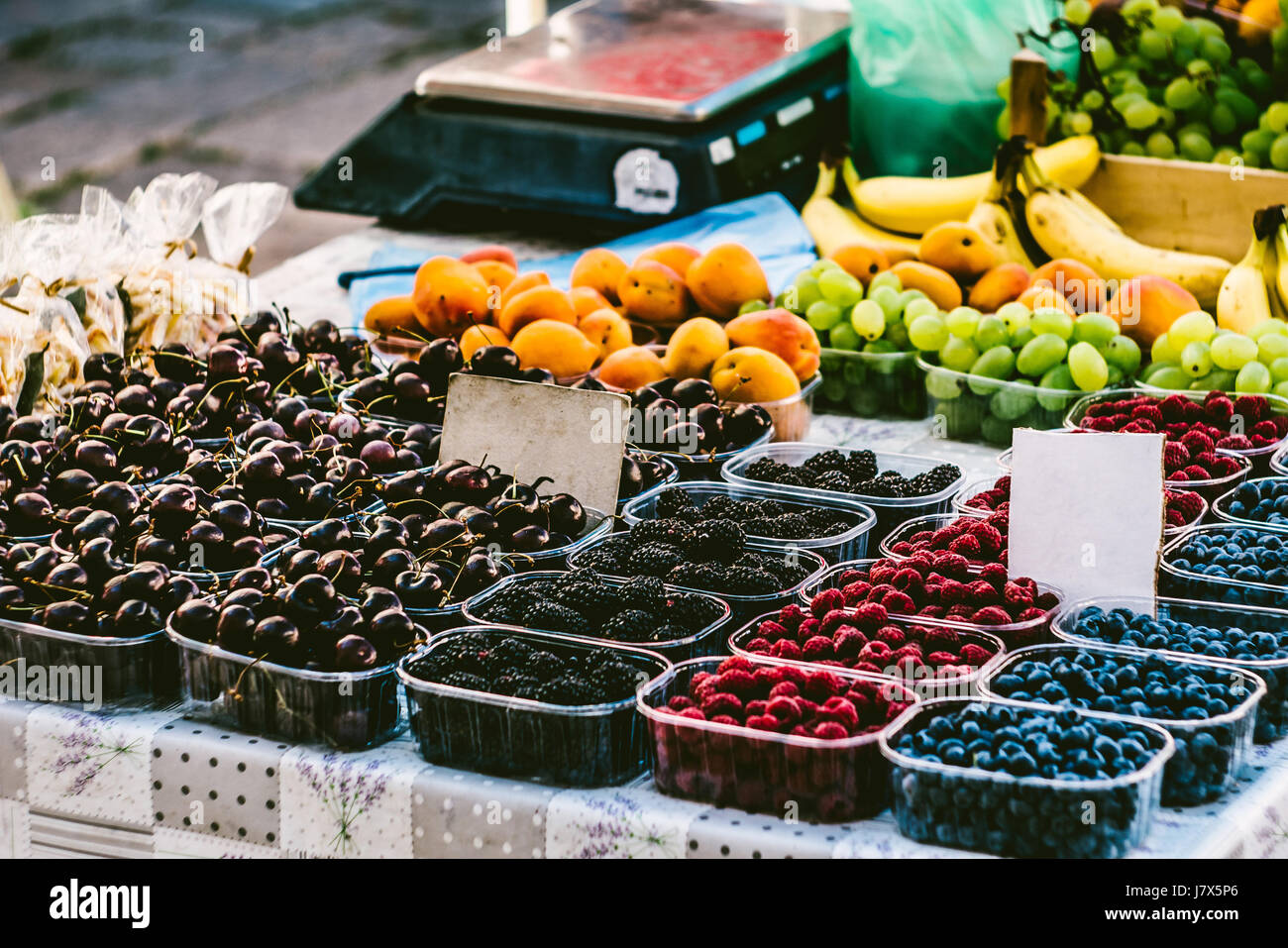 Berries in boxes on the market. Market Showcase with berries. The ...