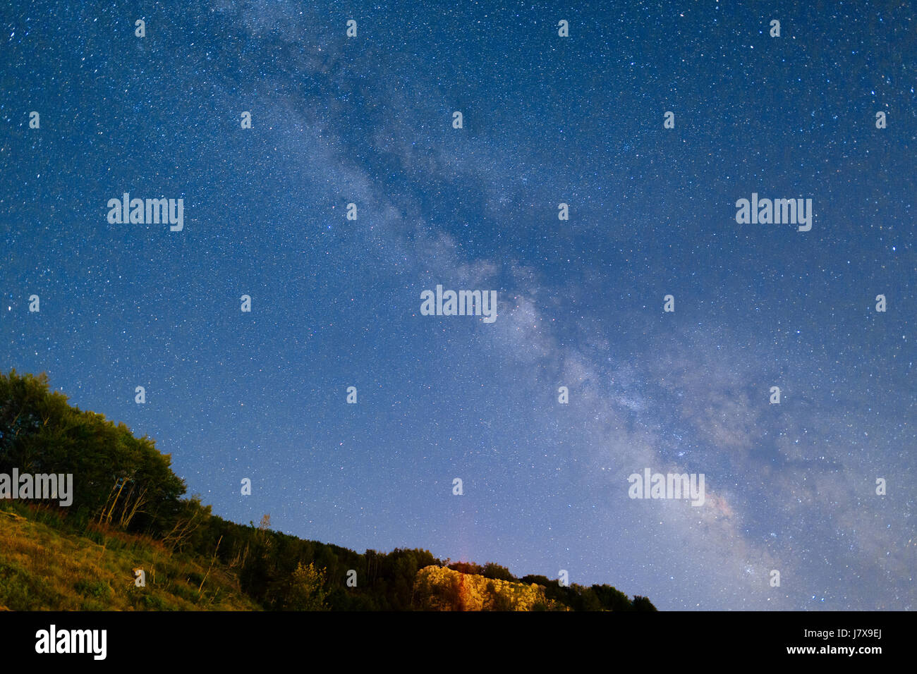 The starry sky and the Milky Way over the mountains and the fore Stock ...