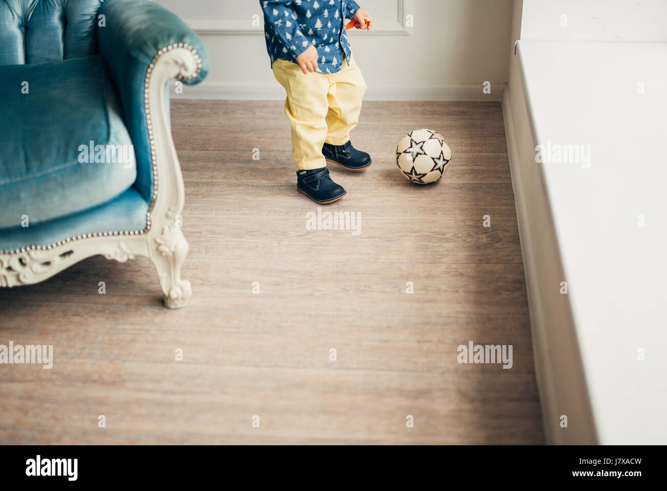 The legs a small child playing ball Stock Photo - Alamy