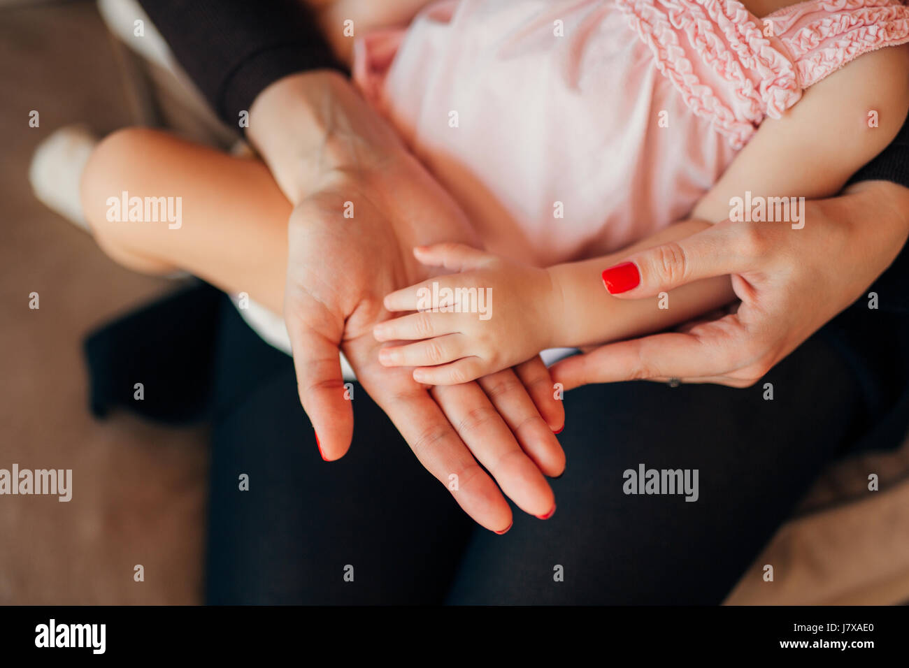 Small children's pens. The child is in the hands of parents Stock Photo ...
