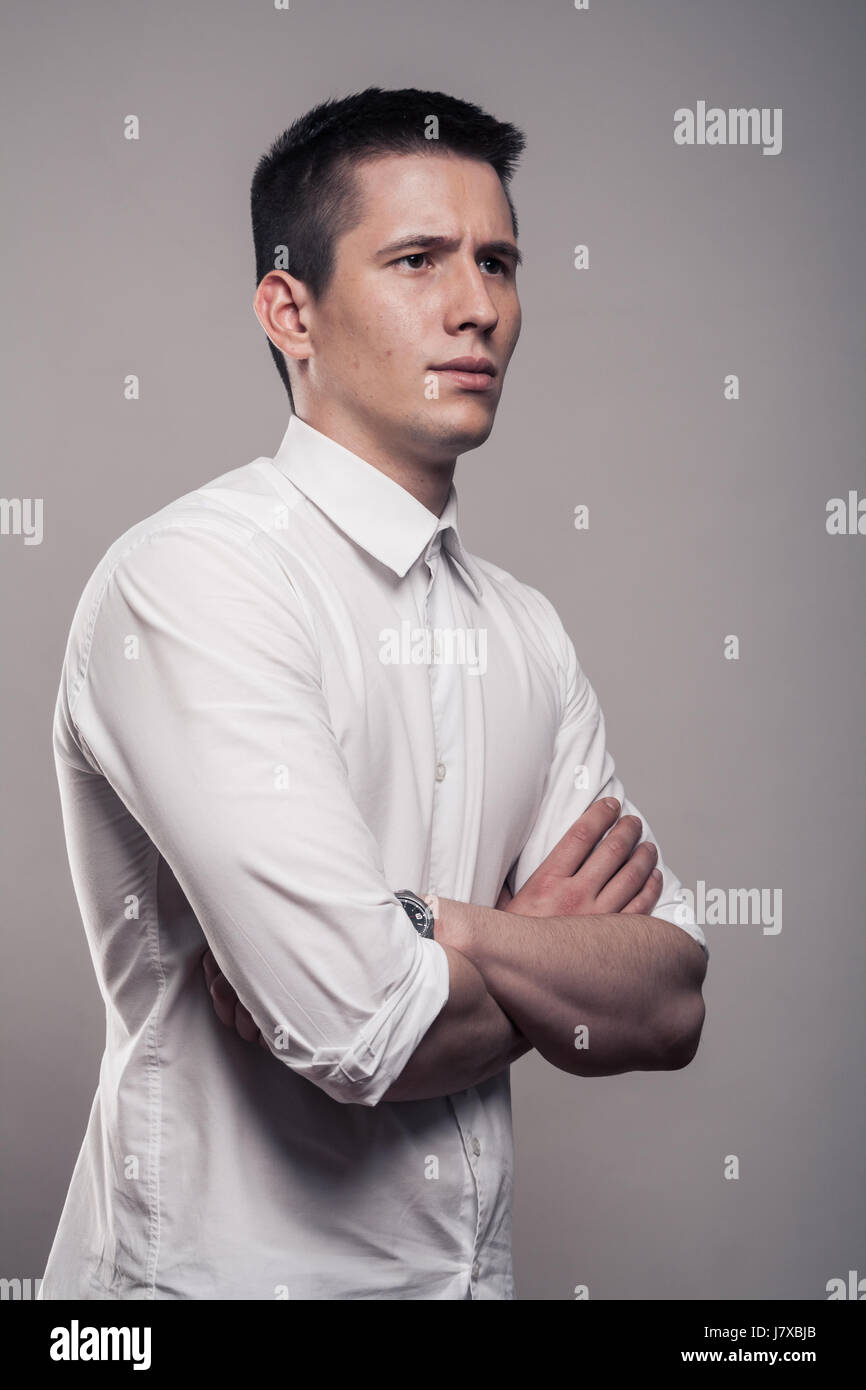 one young man, portrait, upper body, white shirt, studio, gray ...