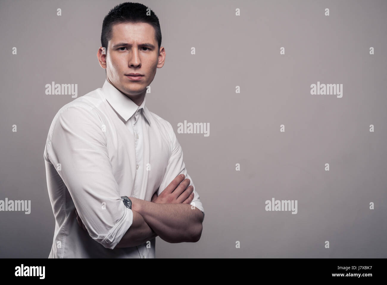 one young man, portrait, upper body, white shirt, studio, gray ...