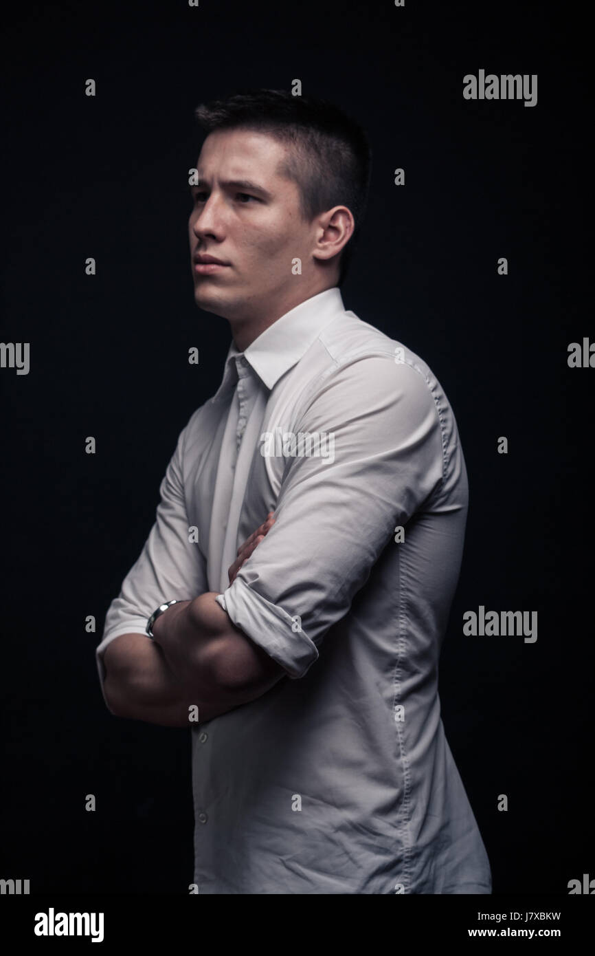 one young adult man only, portrait, looking tense, side view, black ...