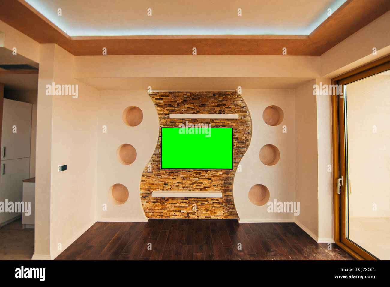 A modern LCD TV with green screen hanging on the wall Stock Photo - Alamy