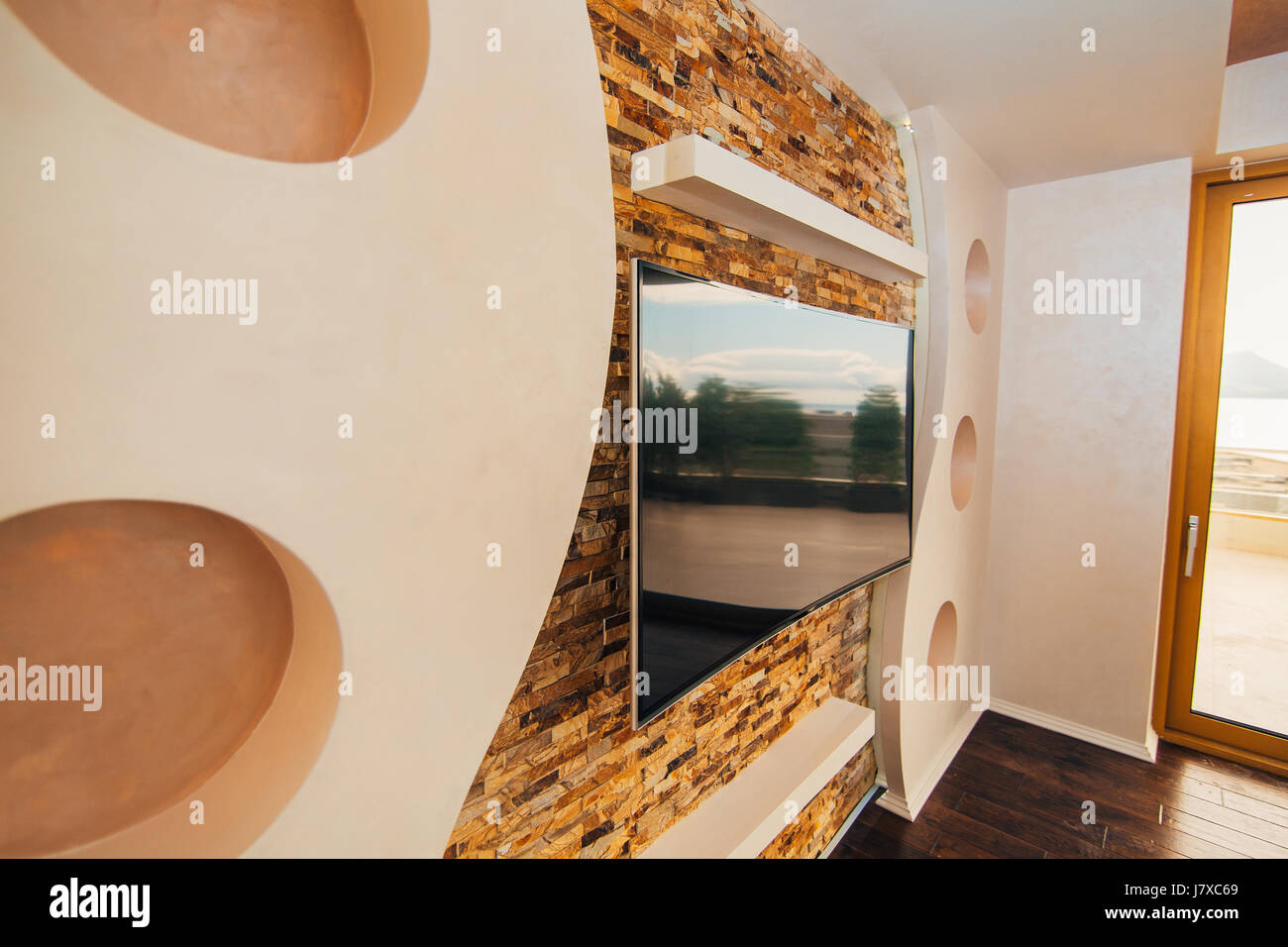 TV on the wall. TV hanging on the wall Stock Photo - Alamy