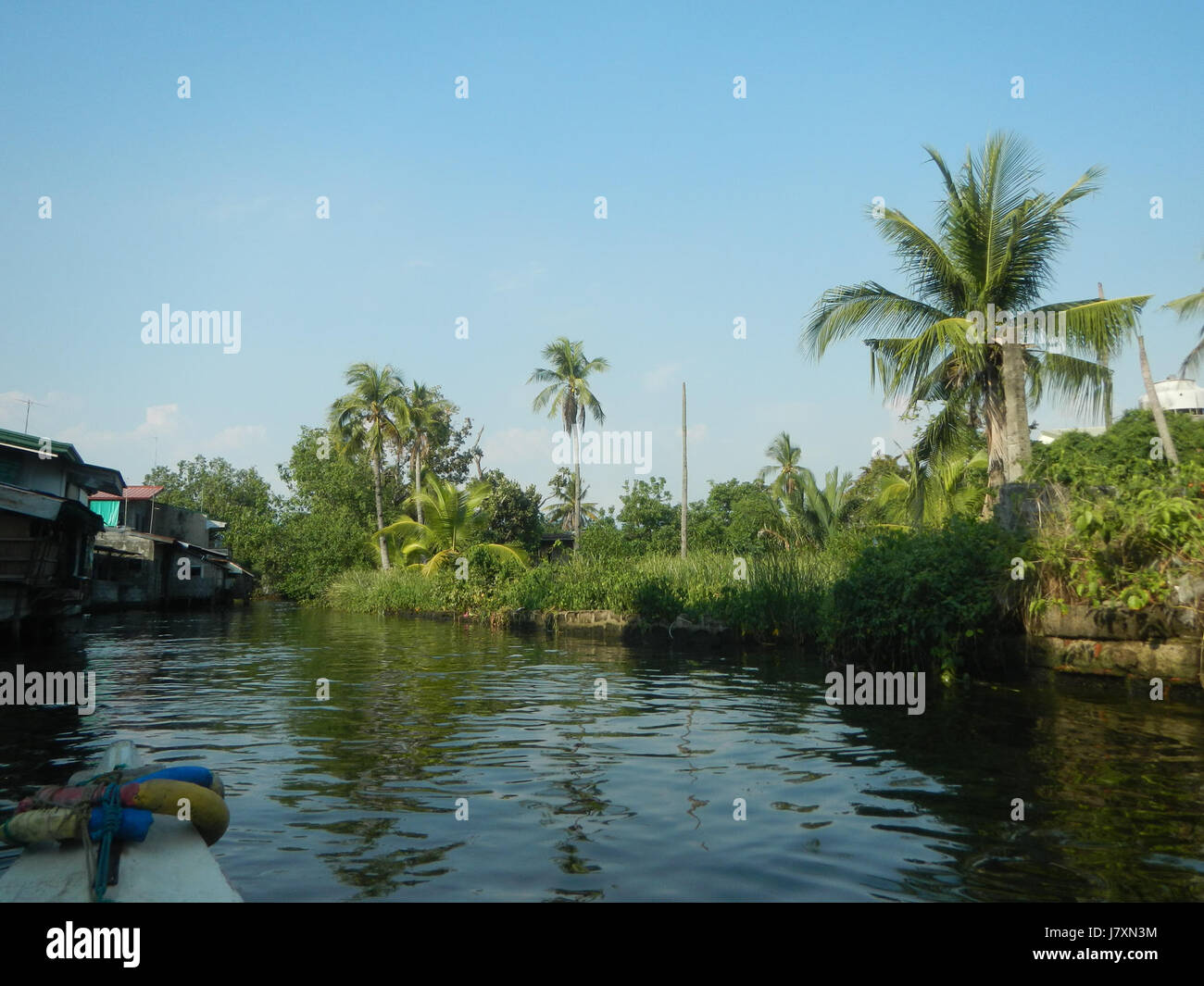 This image features the Malolos River in Bulacan, Philippines ...