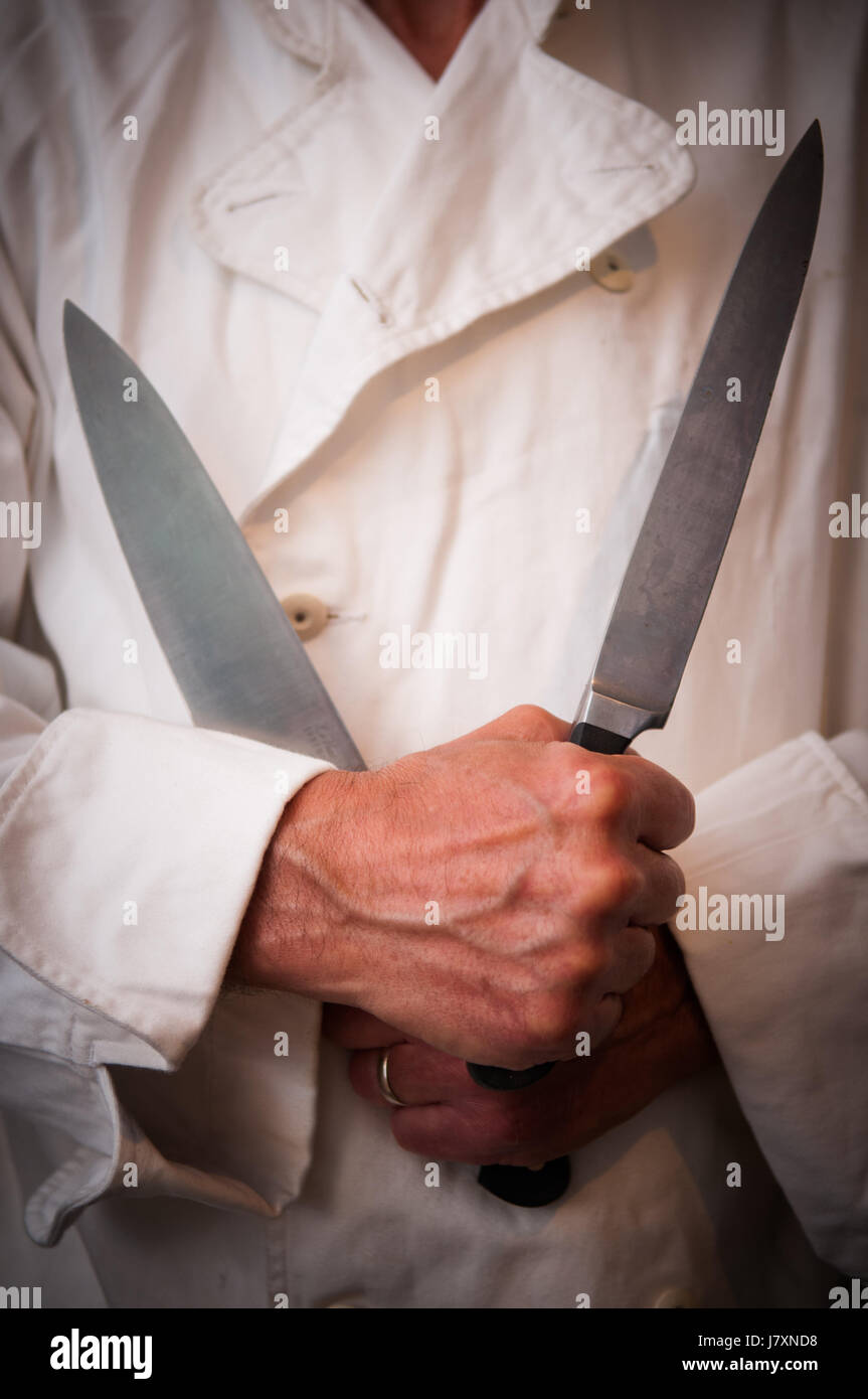 chef using knife held in front of him Stock Photo - Alamy