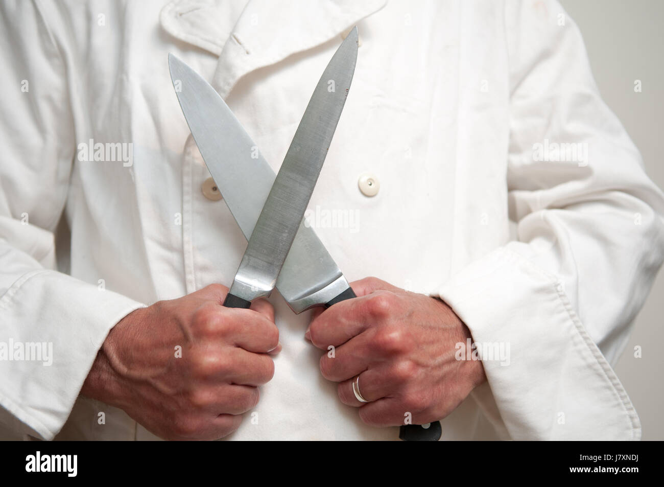 chef using knife held in front of him Stock Photo - Alamy