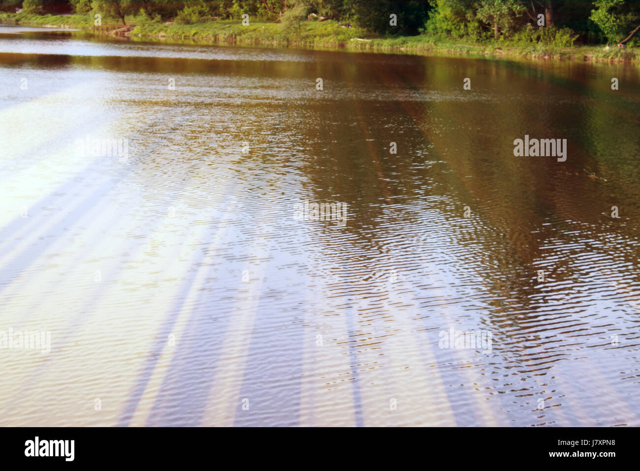 Magic pond. Composition of a pond and rays Stock Photo - Alamy