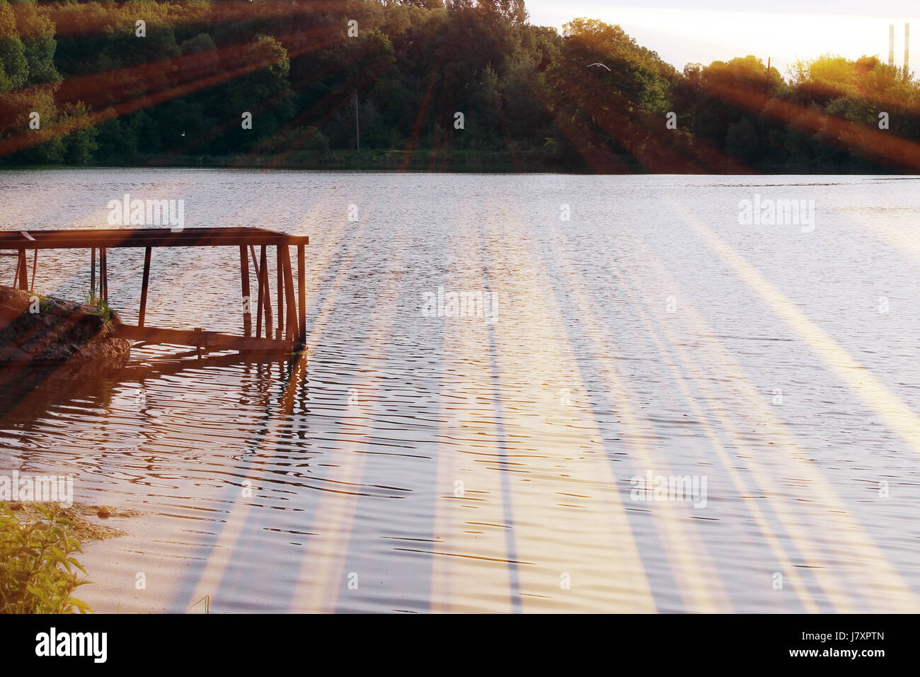 Magic pond. Composition of a pond and rays Stock Photo - Alamy