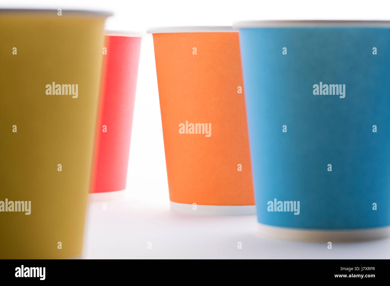 Four colorful paper cups on white background Stock Photo - Alamy
