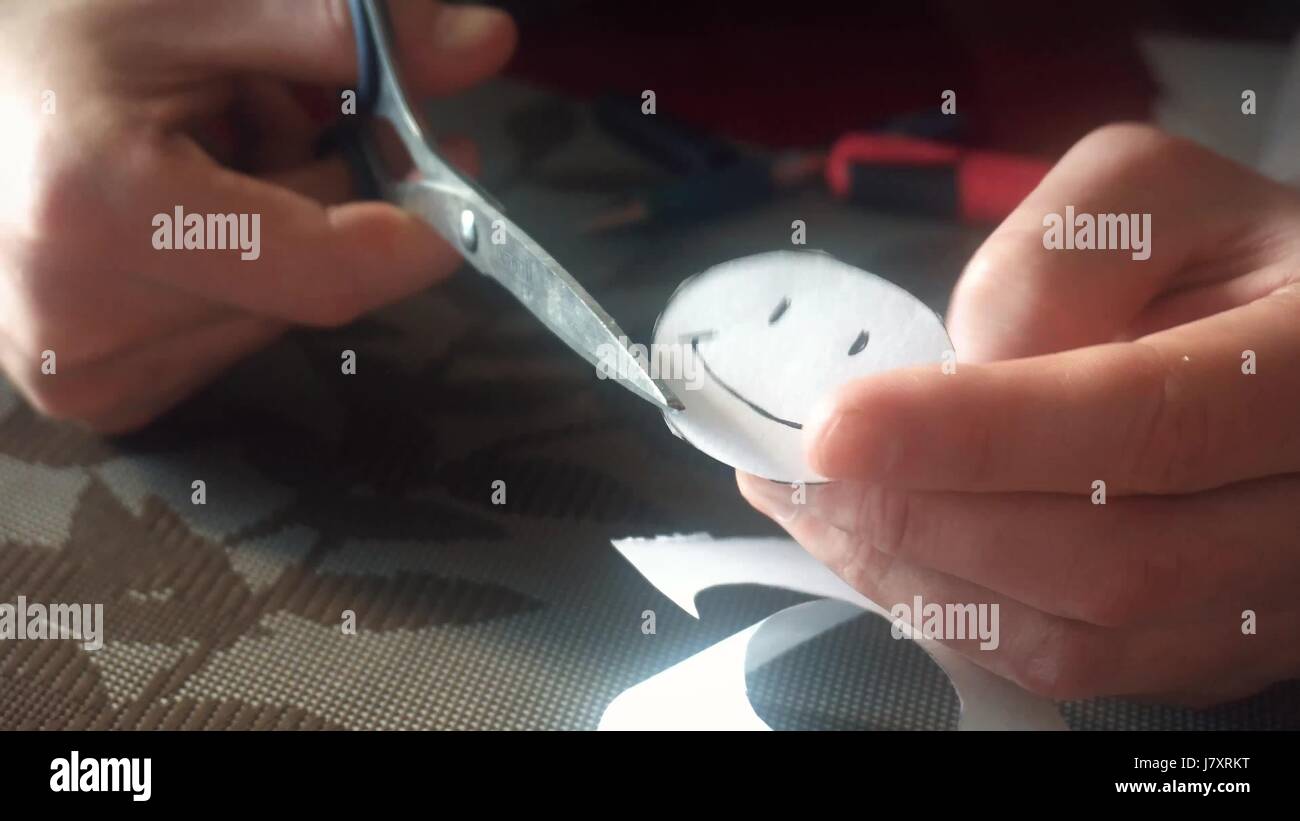 hands of a young man cut a smiley face out of paper Stock Photo - Alamy