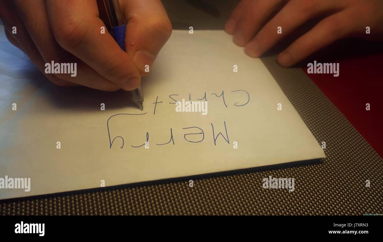 Man hand writing merry christmas with black pencil on white paper. Top ...